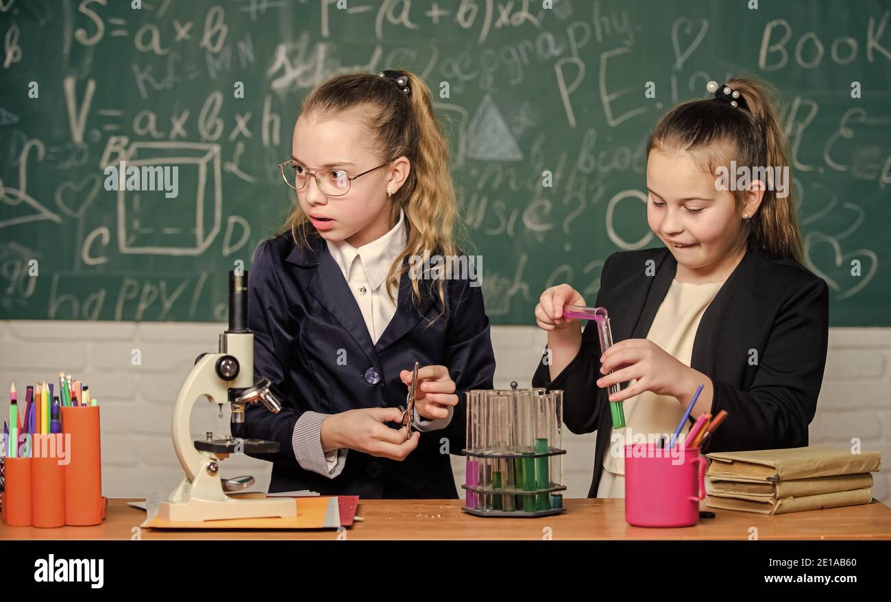 Chemistry research in laboratory. Little girls genius in school lab ...