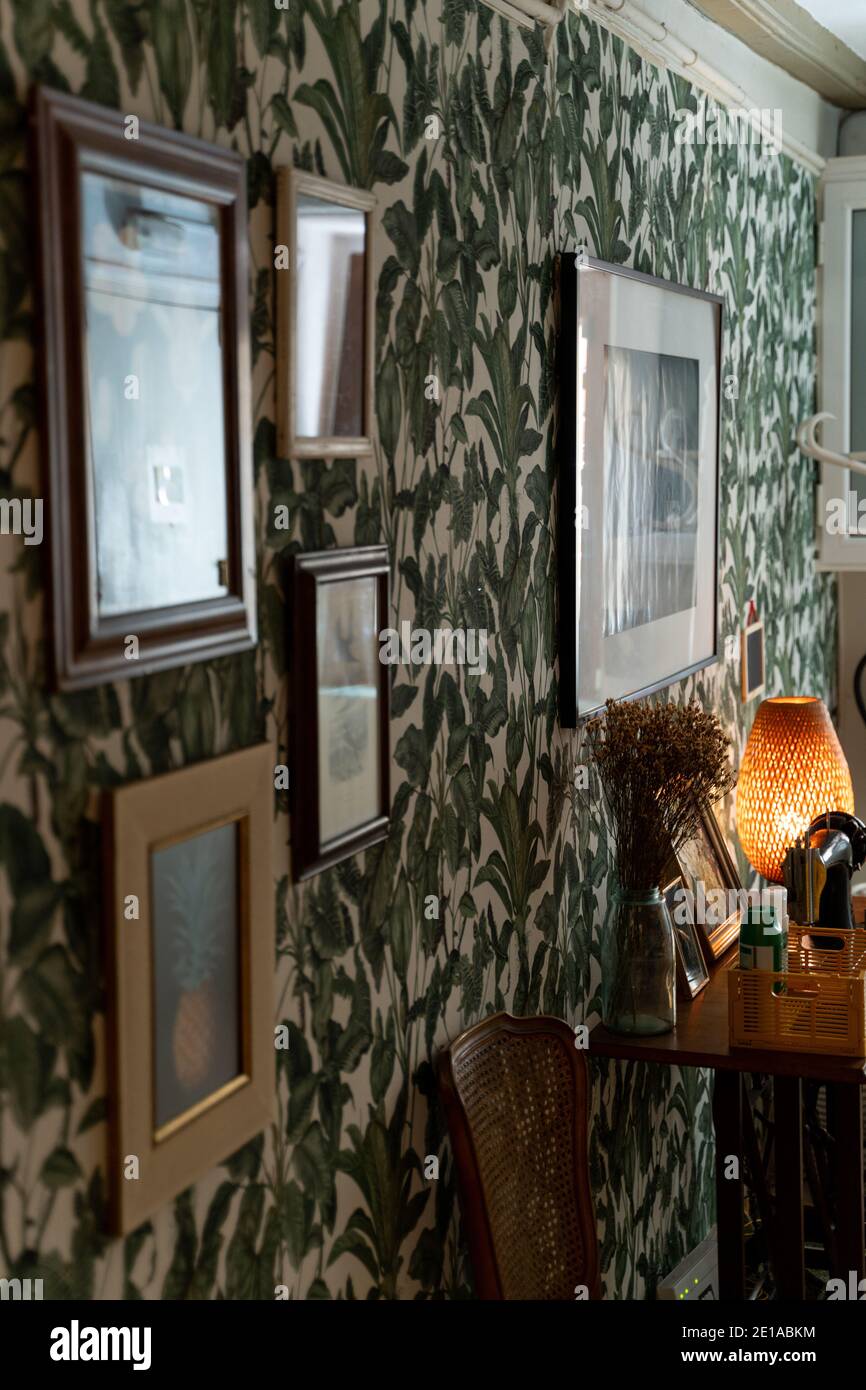 Sewing machine, hourglass and lamp with wallpaper in floral tropical ...