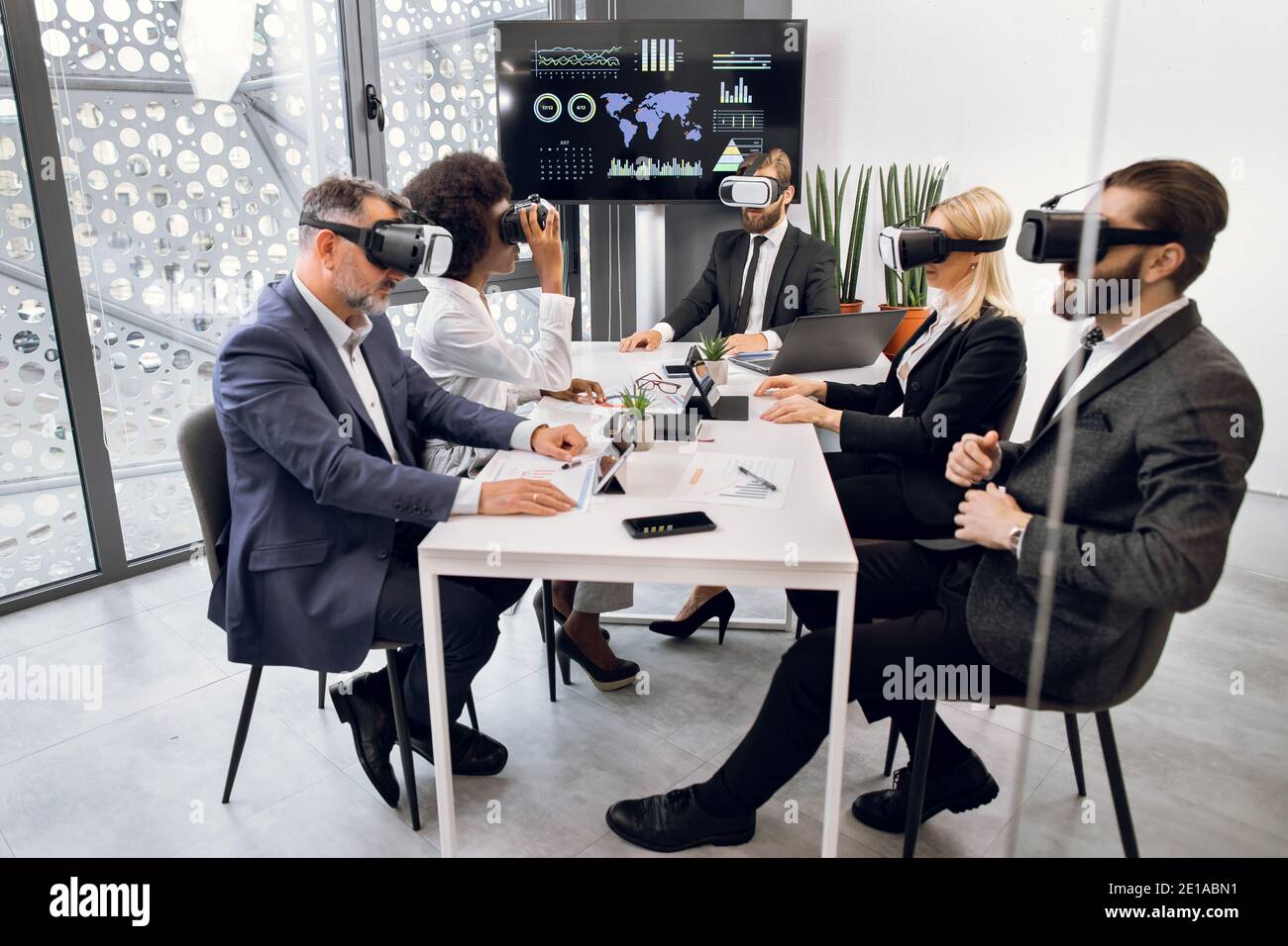 Multiethnic creative business team using virtual reality headsets at ...