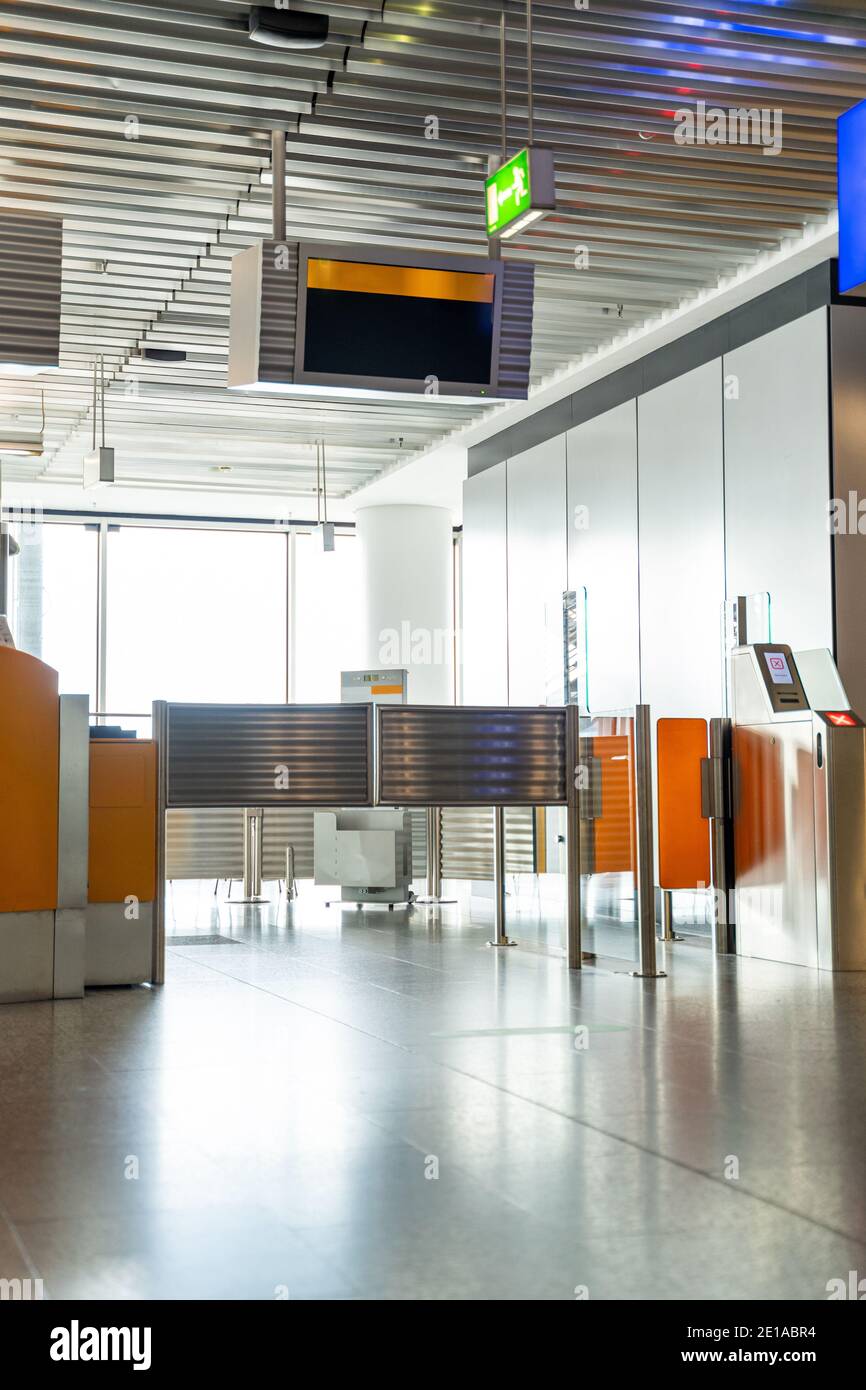 Orange empty airport check-in counter with scoreboard and light from ...