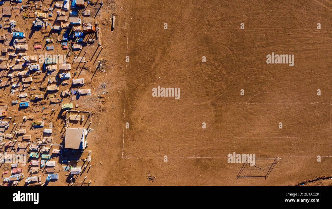 Aerial view of a cemetery, soccer field and dirt baseball fields in the ...