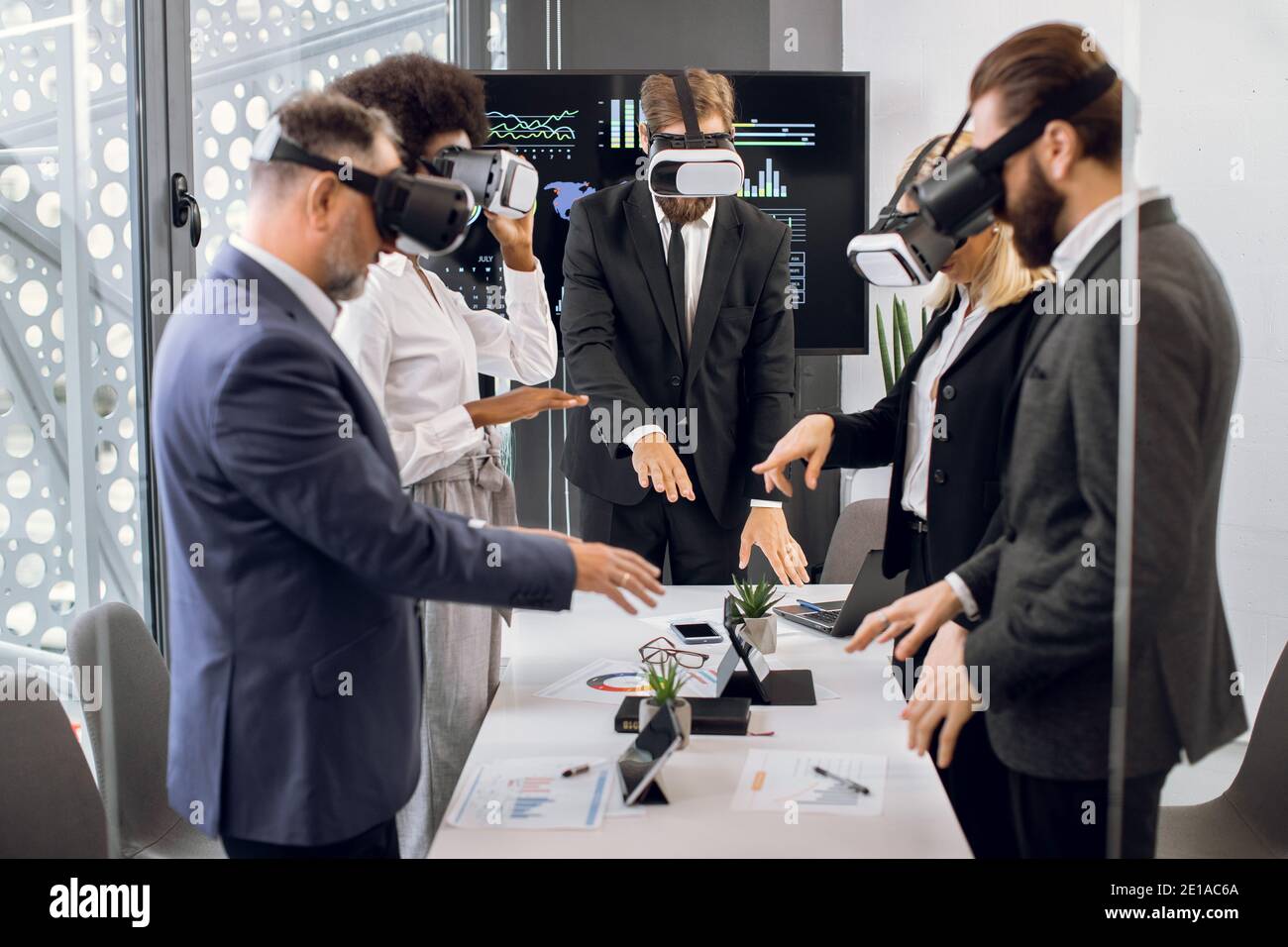 Team of creative multiracial colleagues, designers, architect in formal ...