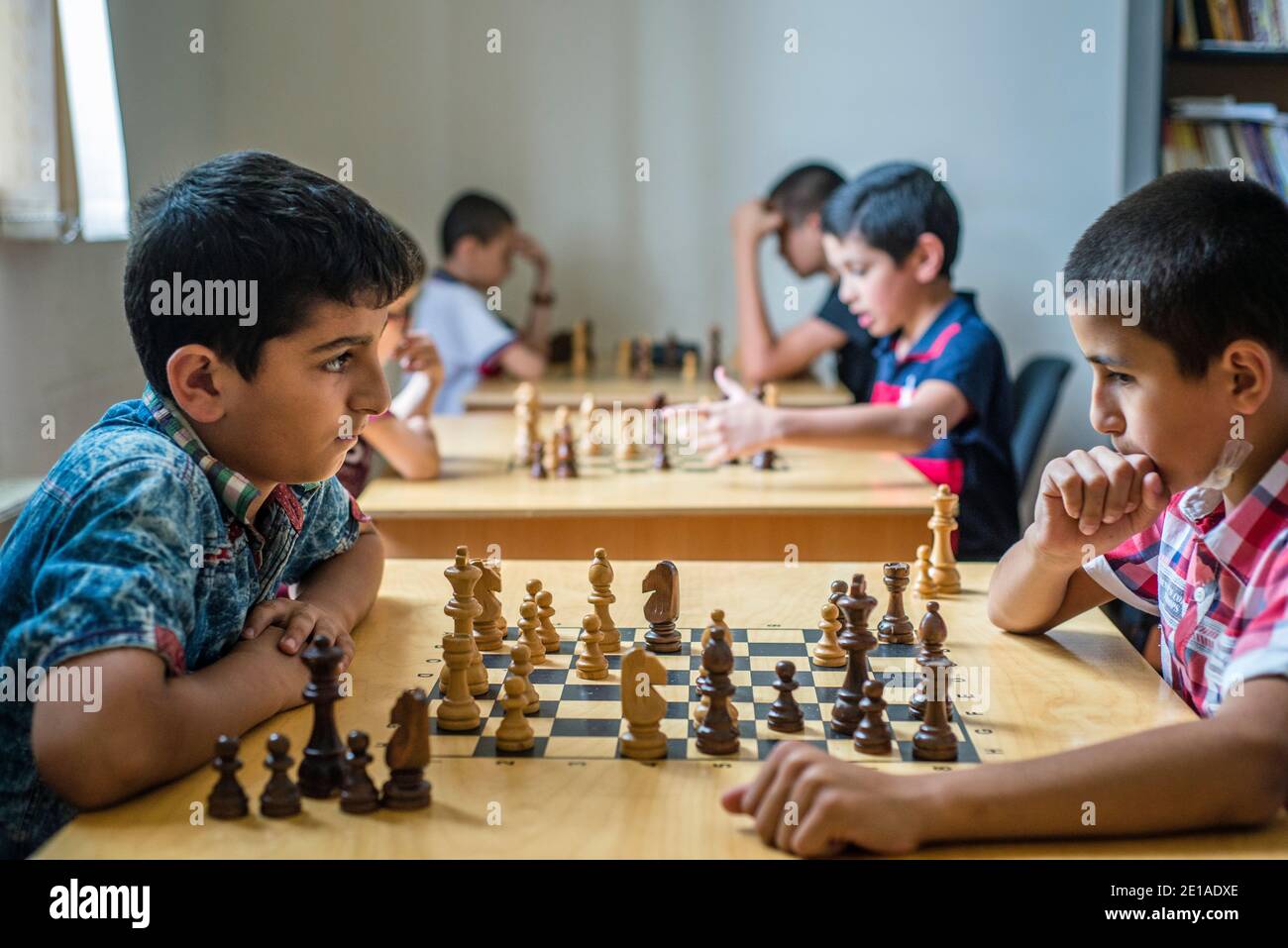 Children playing chess in classroom hi-res stock photography and images ...
