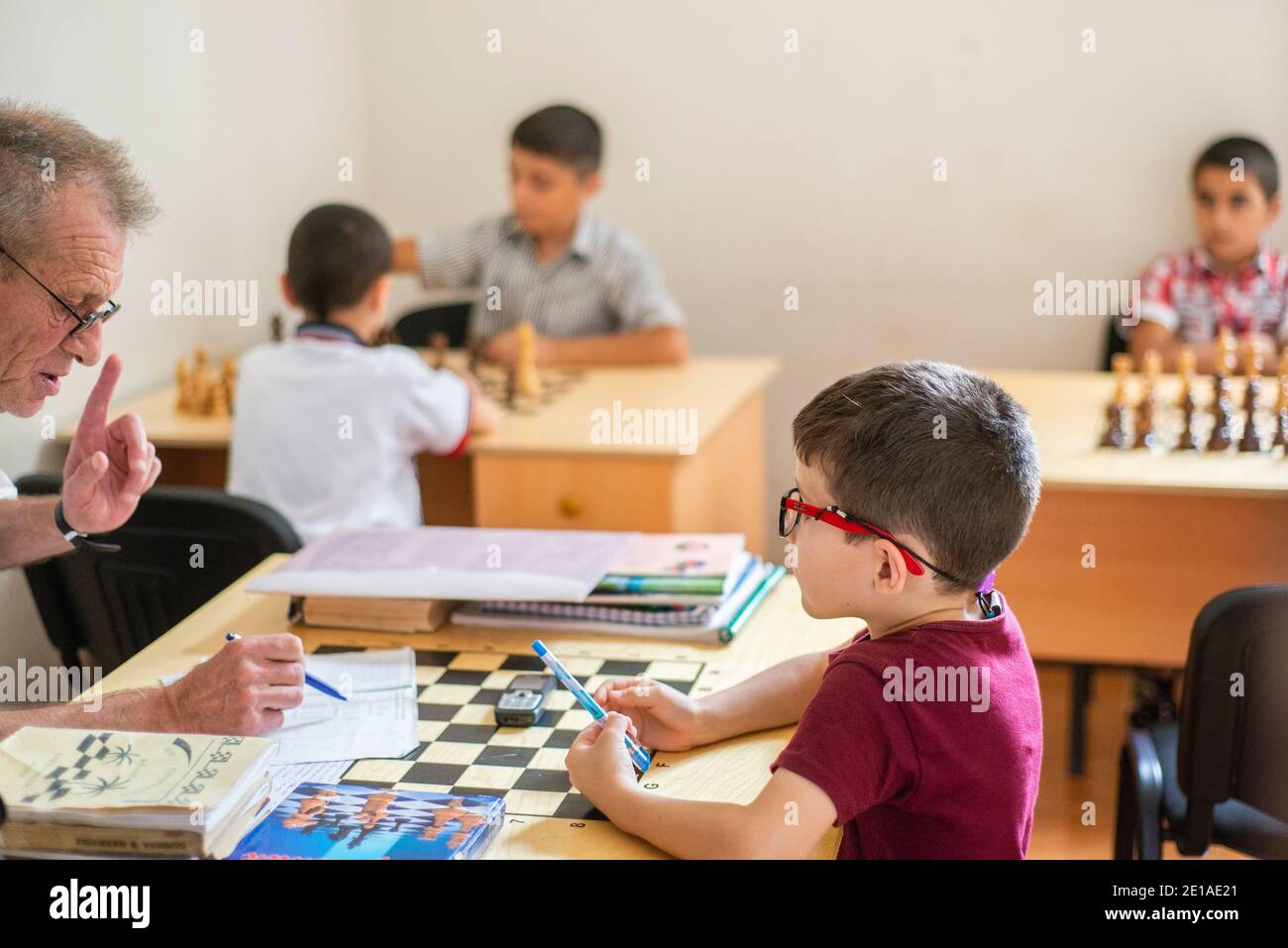 Learners of the Quba Chess School play chess during a training lesson ...