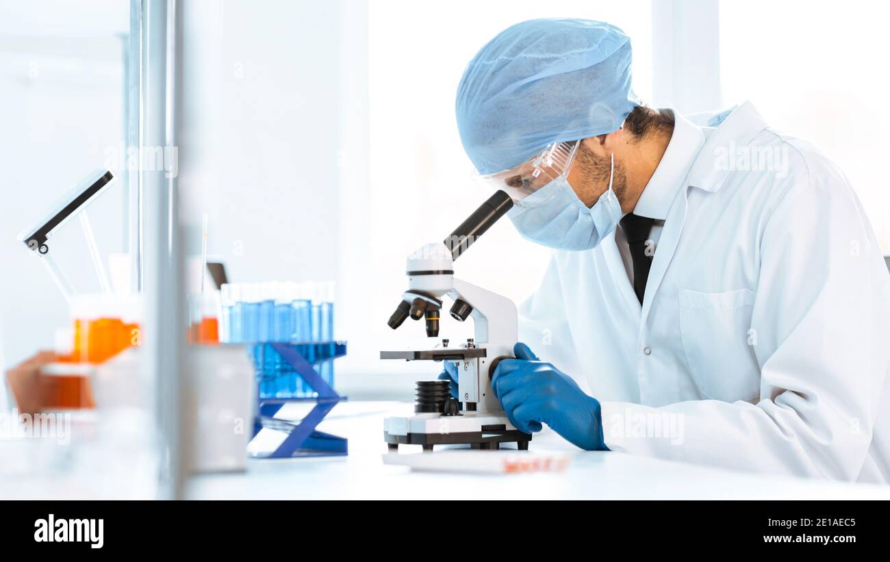 close up. scientist looking into the eyepiece of a microscope Stock ...