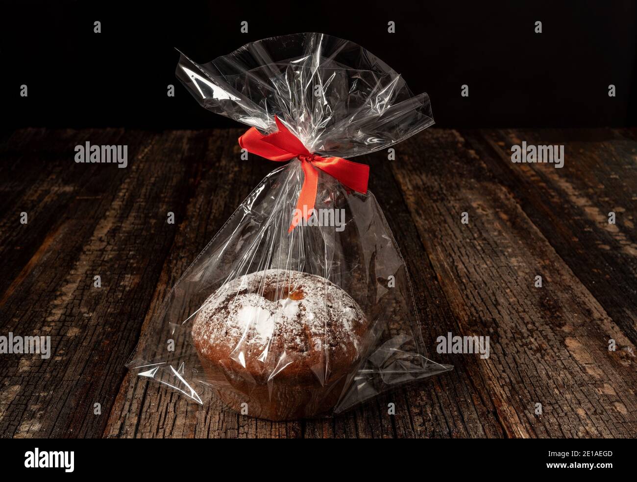 Stollen rye bread, round, packed in a plastic bag, on a wood textured ...