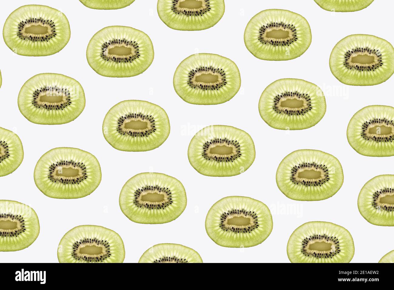 Pattern made of backlit kiwi fruit slices on white background Stock ...