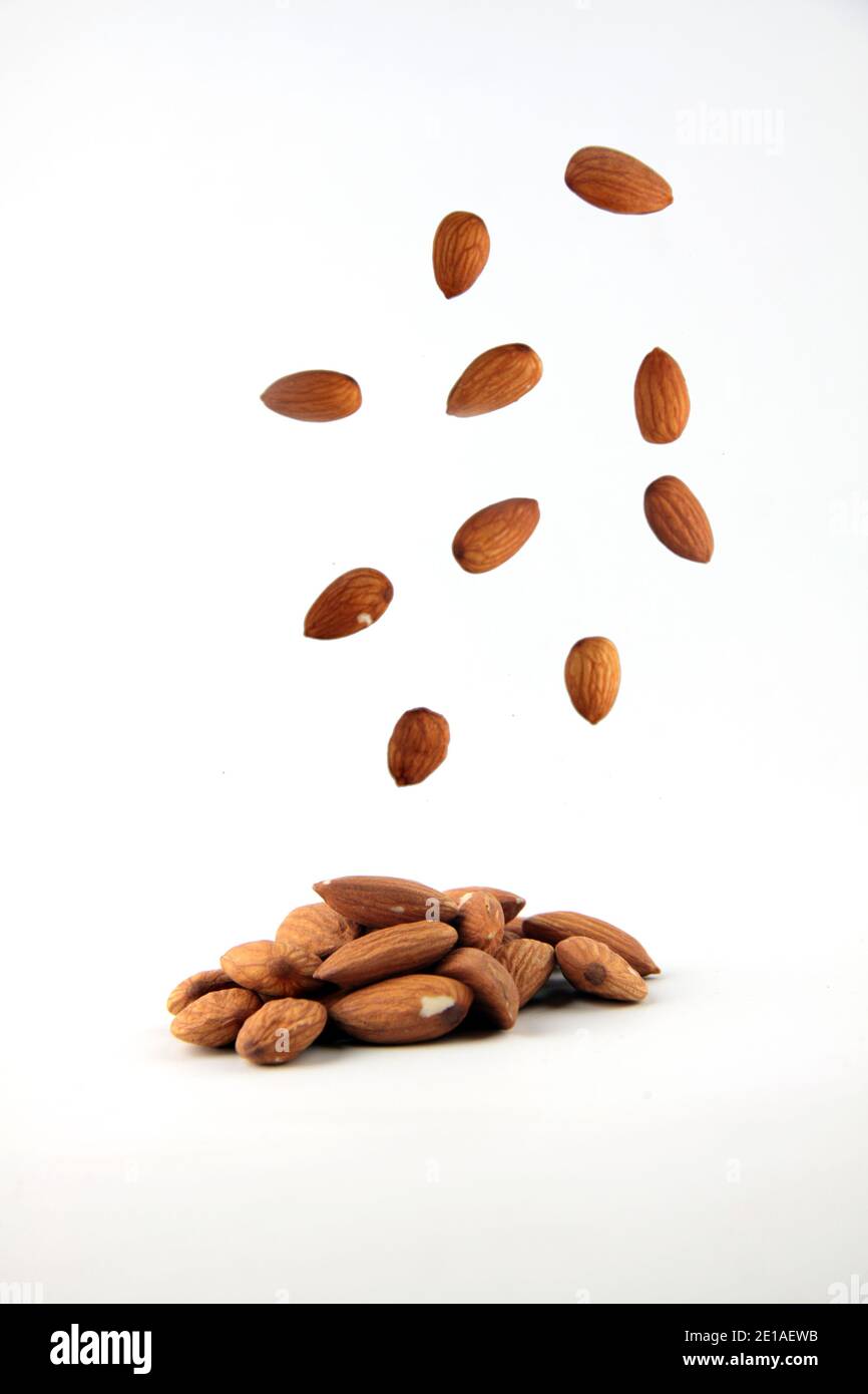 almond pouring against white background. Concept of flying food. Image ...