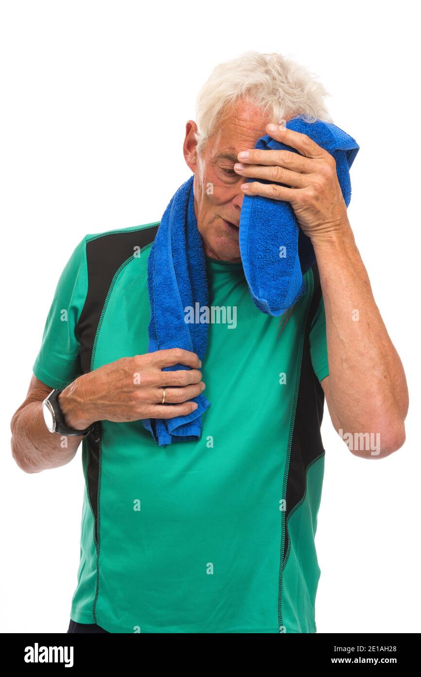Portrait senior sport man drying head with towel against white ...