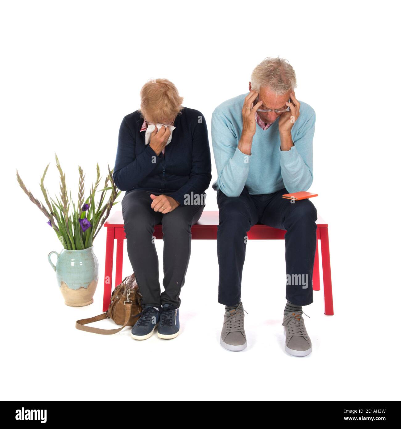 Sadness senior couple in waiting room isolated over white background ...