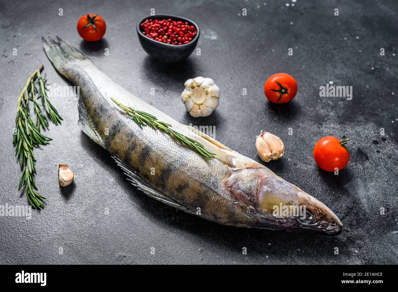 Raw zander, walleye fish with herbs. Black background. Top view Stock ...