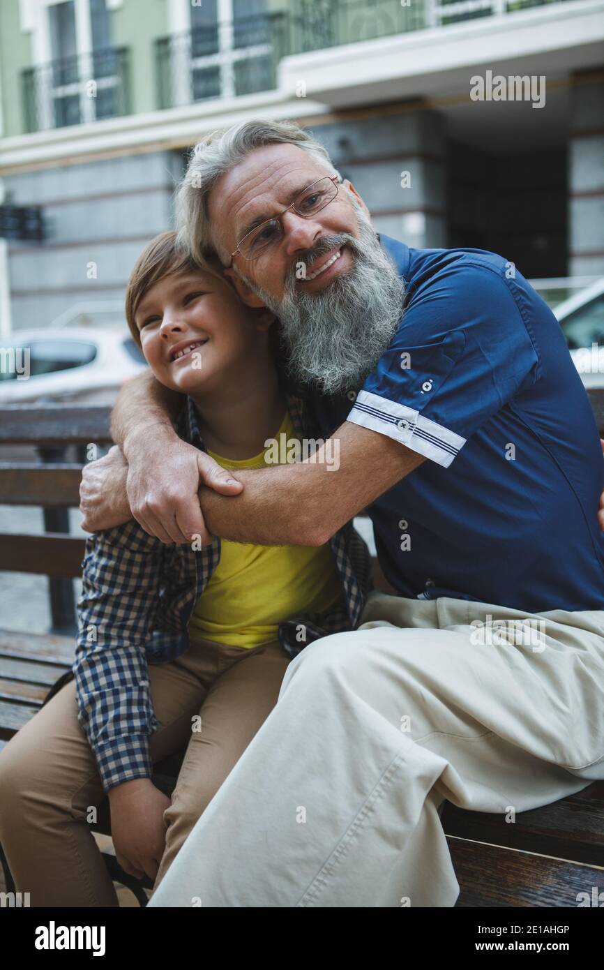 Grandson hugging grandpa hi-res stock photography and images - Alamy