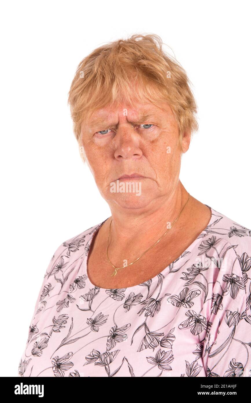 Portrait angry blonde senior woman on white background Stock Photo - Alamy