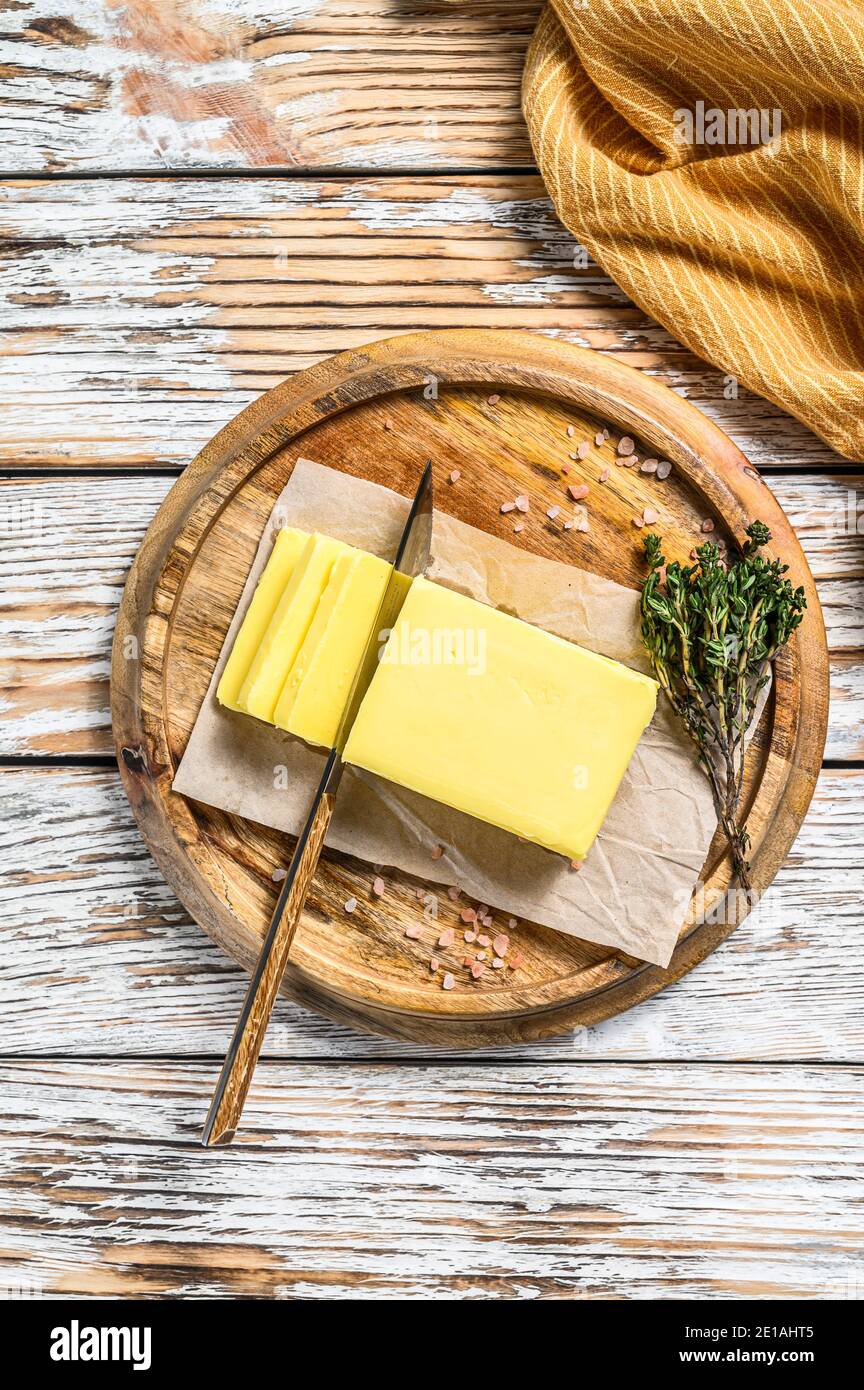 Block of fresh Butter, dairy farm products. White wooden background.Top ...