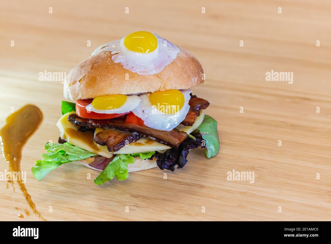 Full picture of a fully stuffed quail egg sandwich, layered with cheese ...