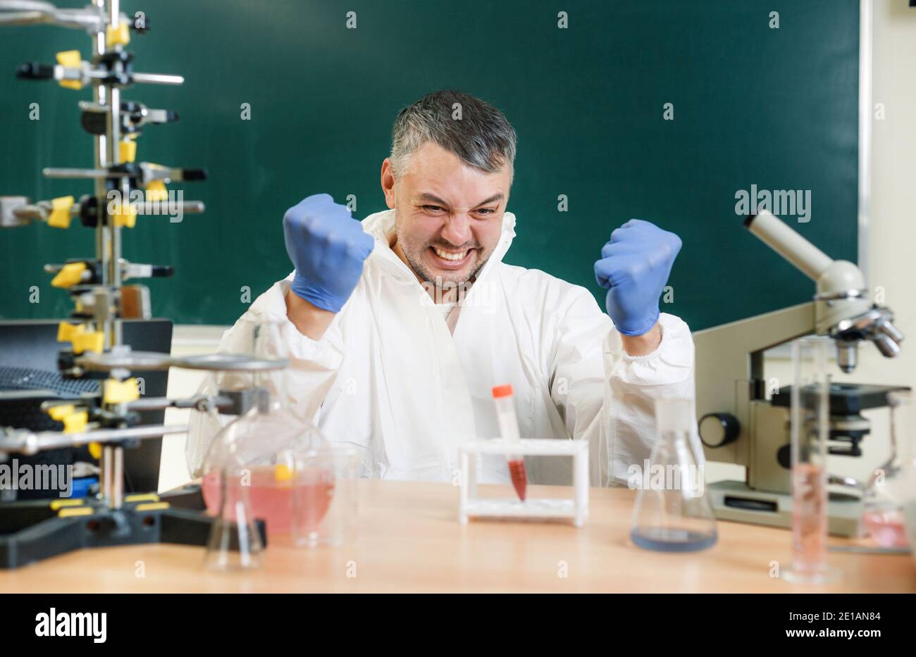The scientist chemist in the laboratory is satisfied with the result of ...