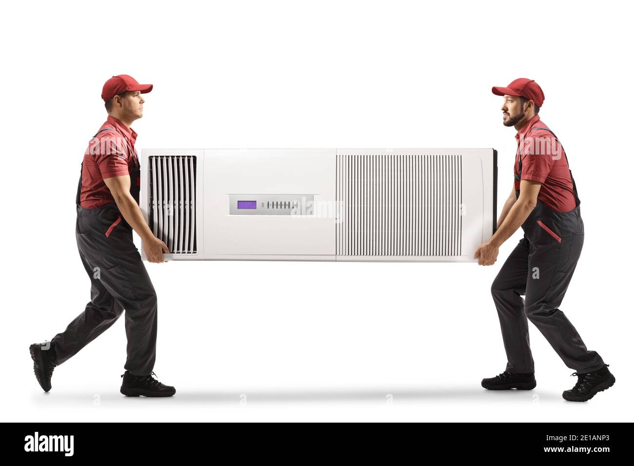 Workers carrying a self standing portable air conditioning unit ...