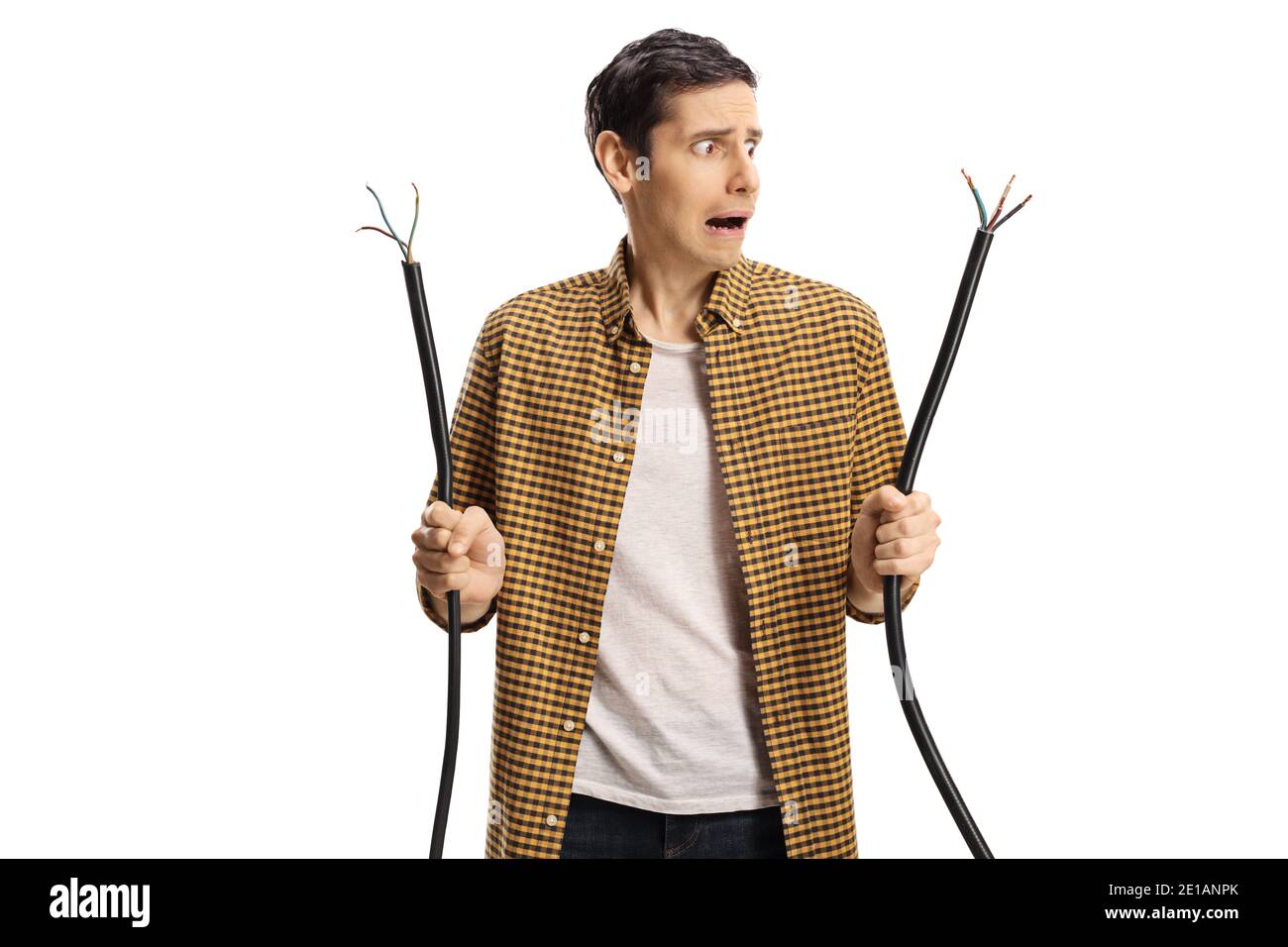 Scared man holding a broken elecrtic cable and looking at it isolated ...