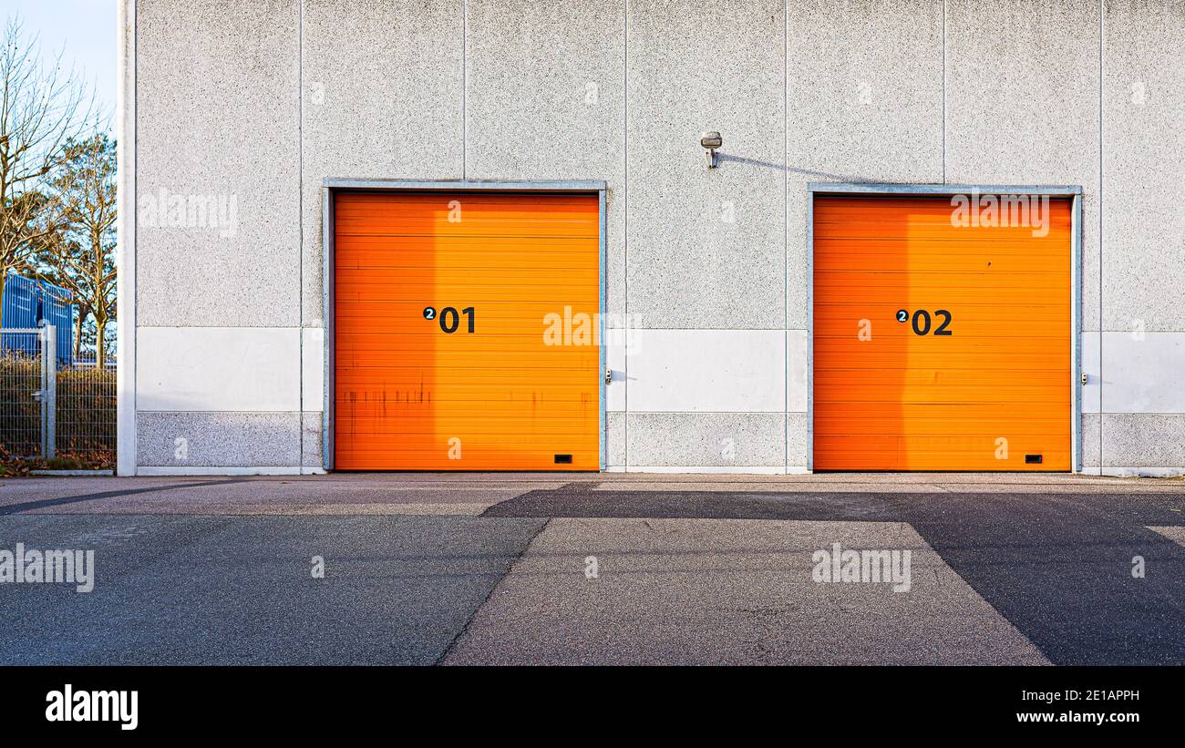 concrete wall with two orange gates with roller shutters, January 2 ...