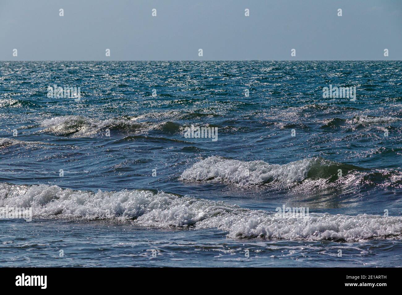Beautiful landscape from a moving ocean waves reaching gently the sandy ...