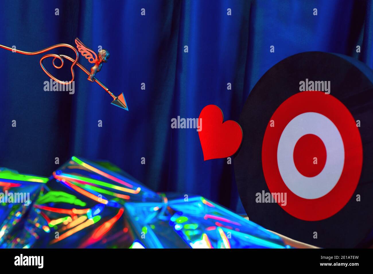 Small golden cupid marks his target with an arrow at the heart ...