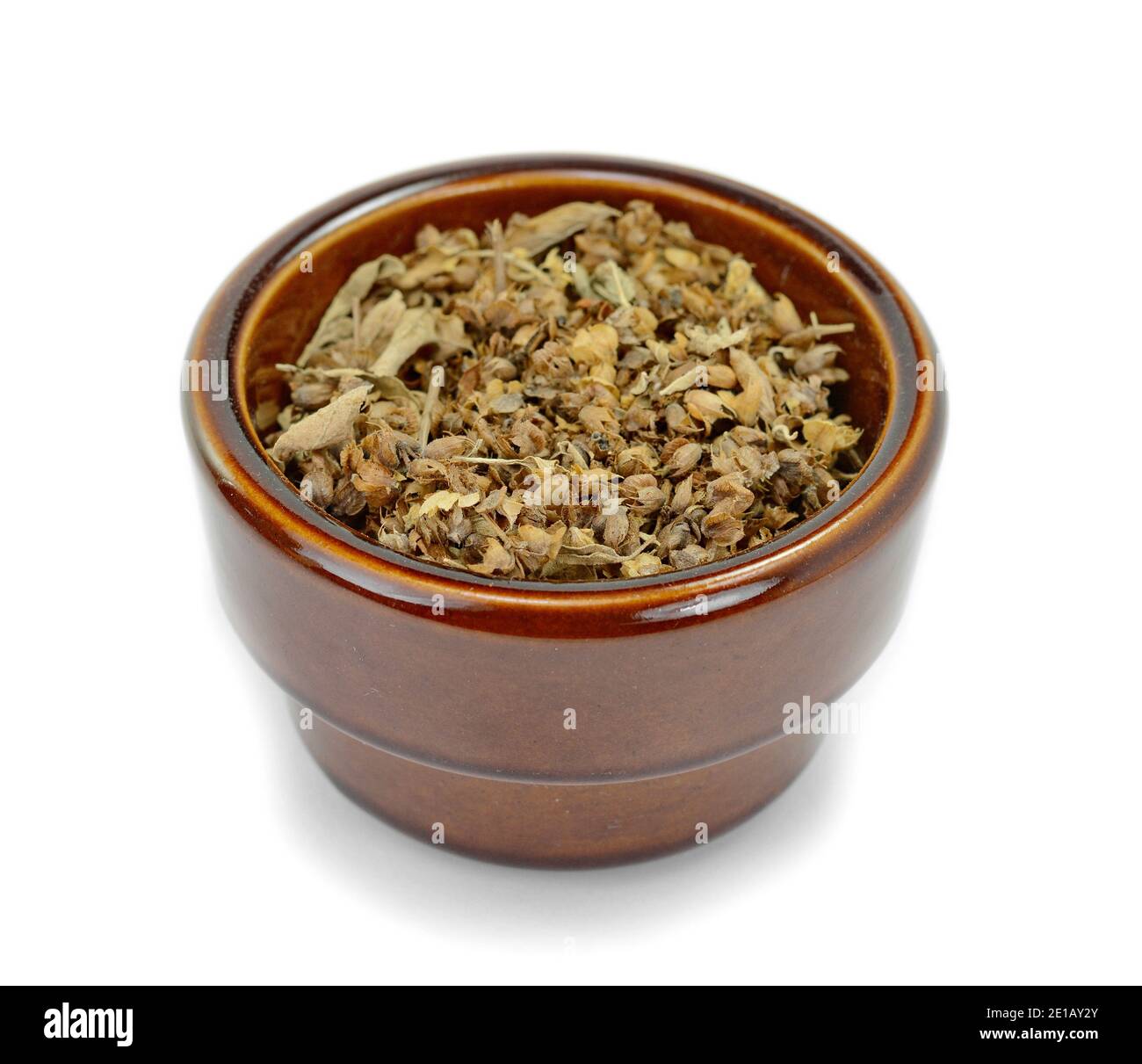 Dried natural basil spice in a ceramic bowl (Ocimum basilicum). Pile of ...