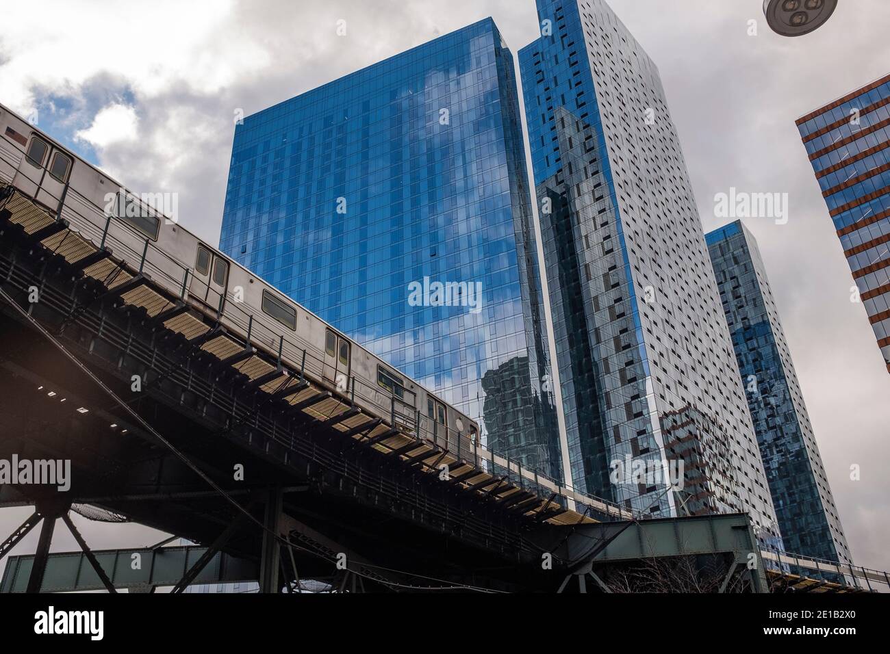 Elevated trains in between buildings Stock Photo - Alamy