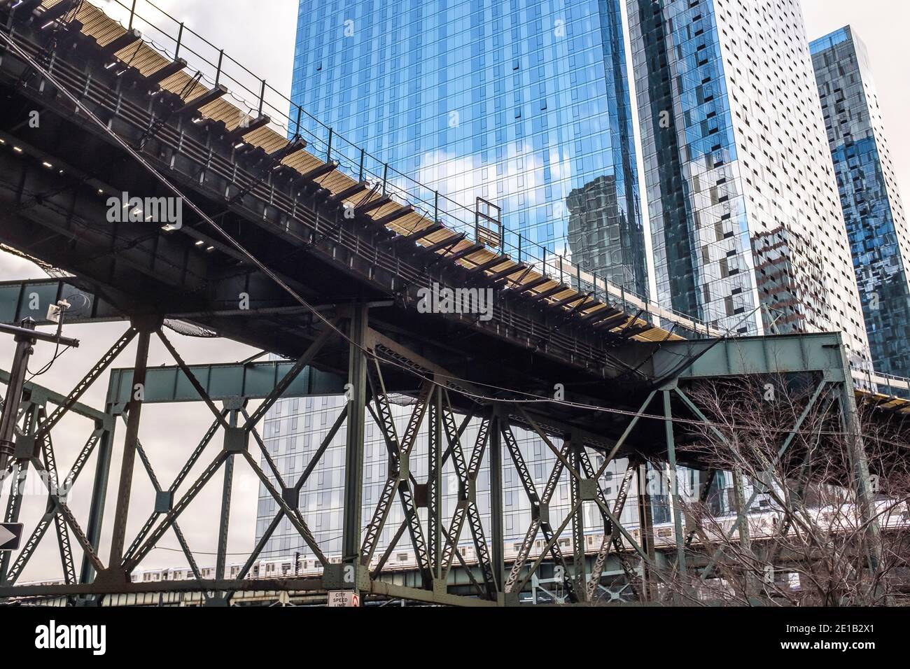 Elevated trains in between buildings Stock Photo - Alamy