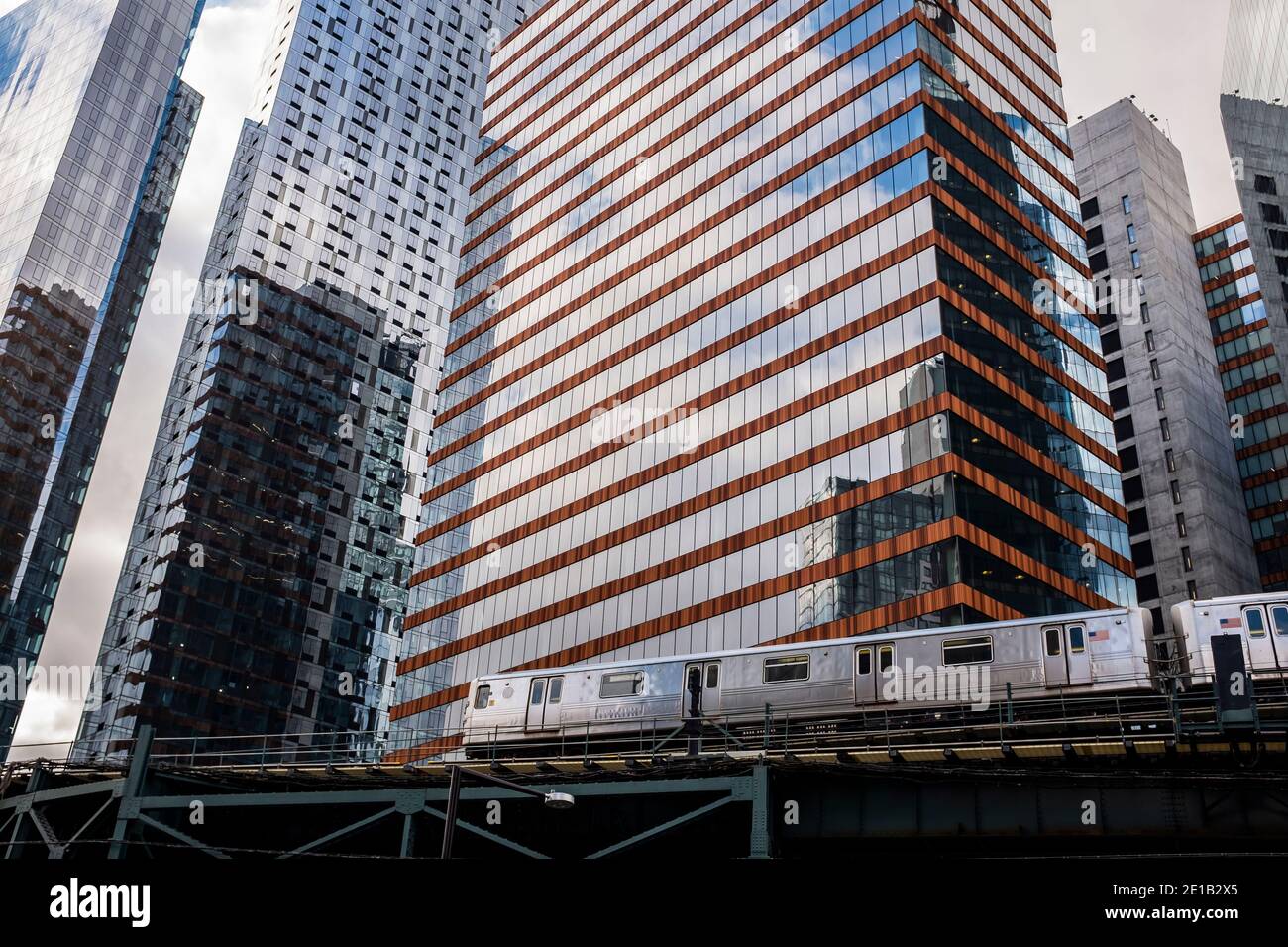 Elevated trains in between buildings Stock Photo - Alamy
