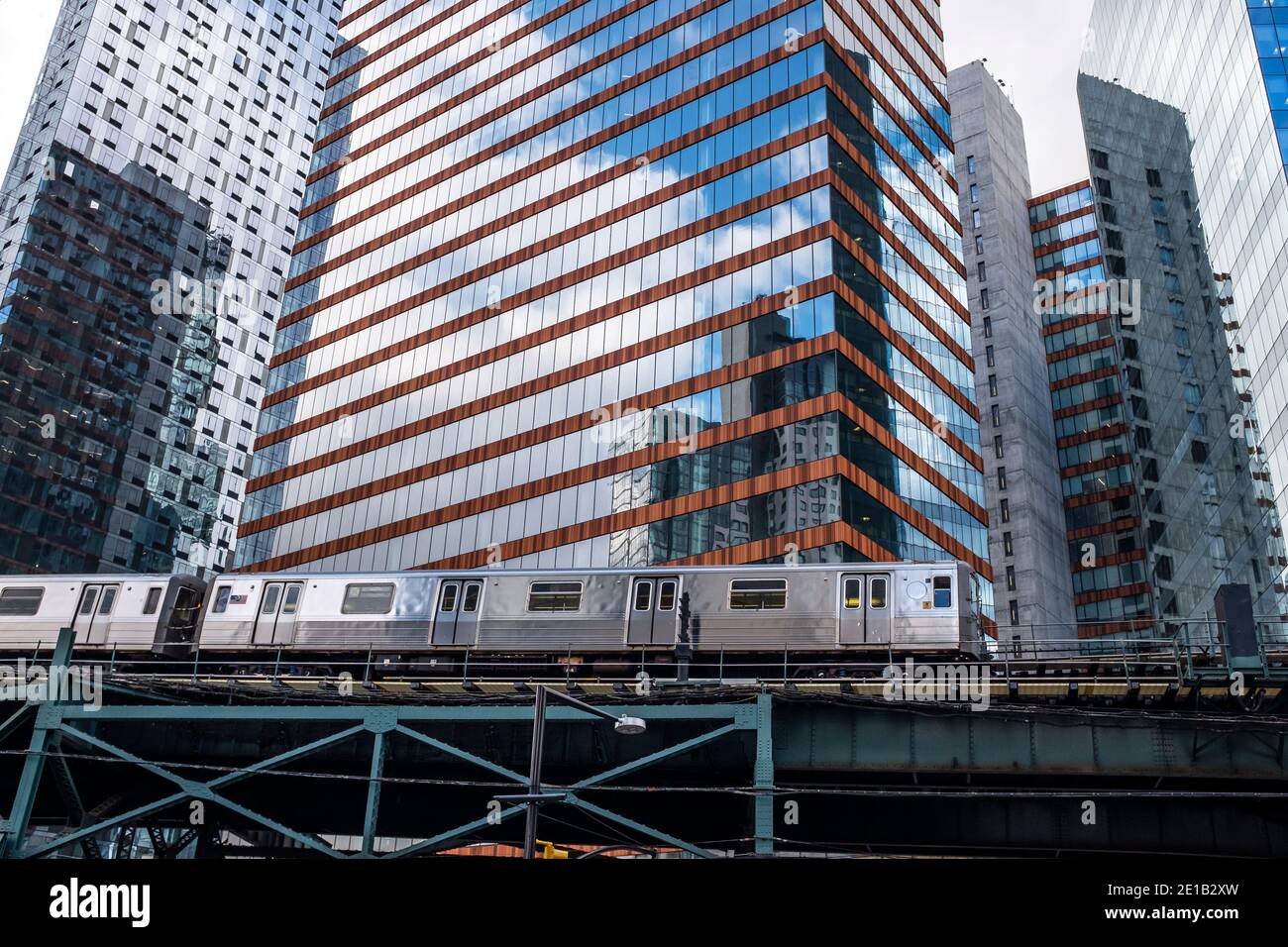 Elevated trains in between buildings Stock Photo - Alamy