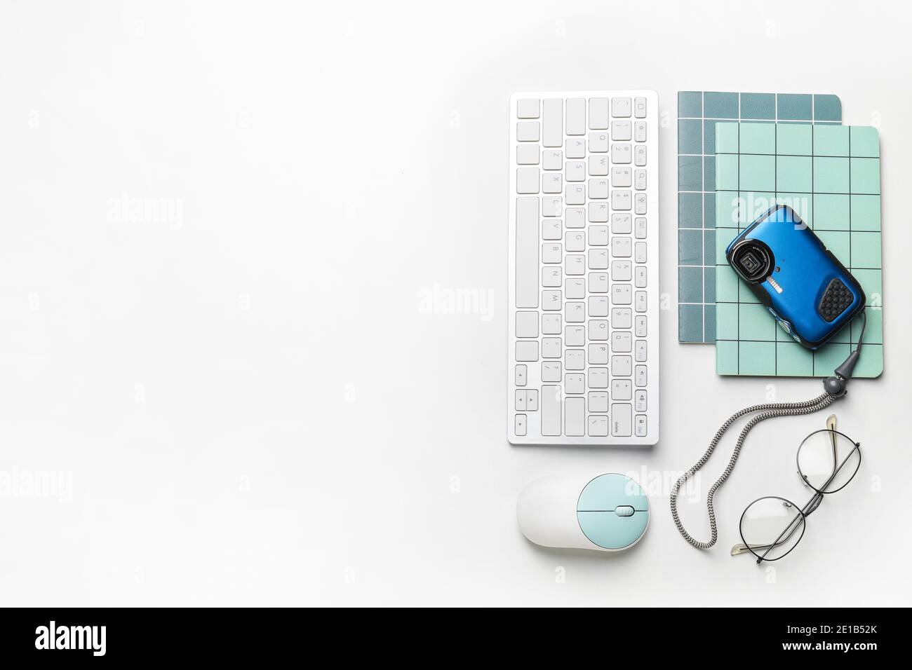 Composition with computer keyboard, mouse and camera on white ...