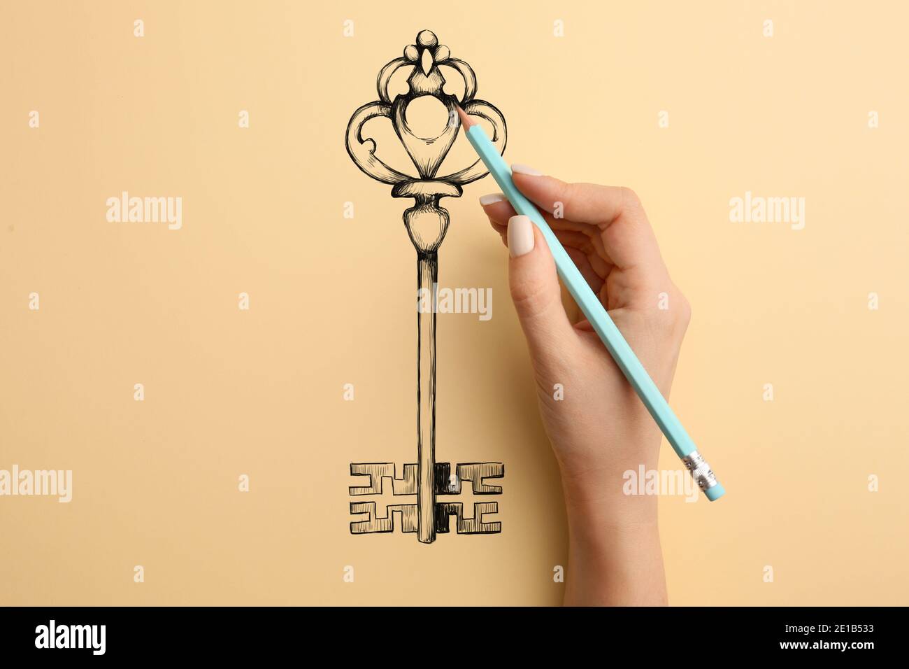 Woman with pencil drawing key on color background Stock Photo - Alamy