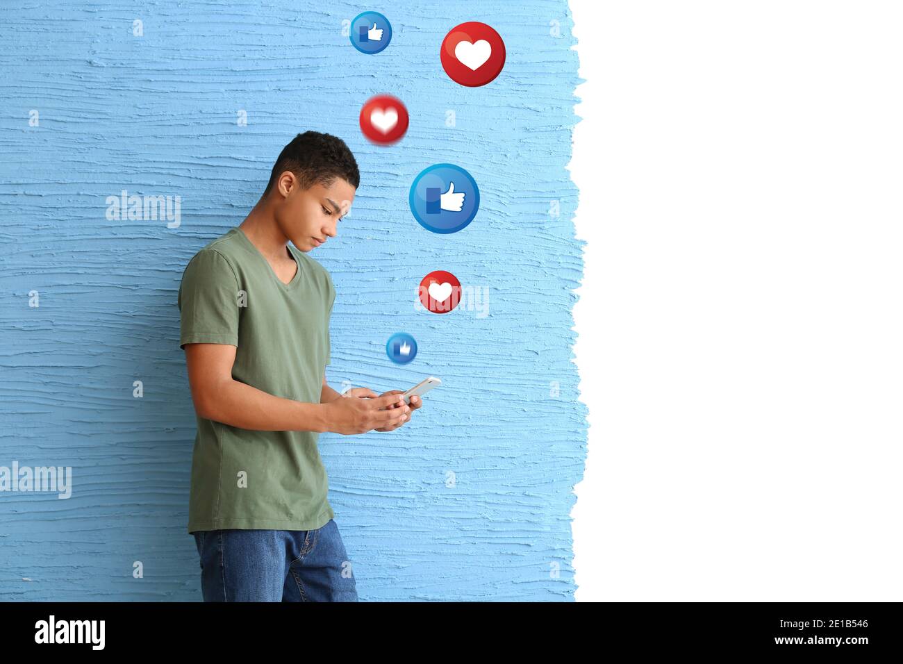 African-American teenage boy using mobile phone for social networking ...