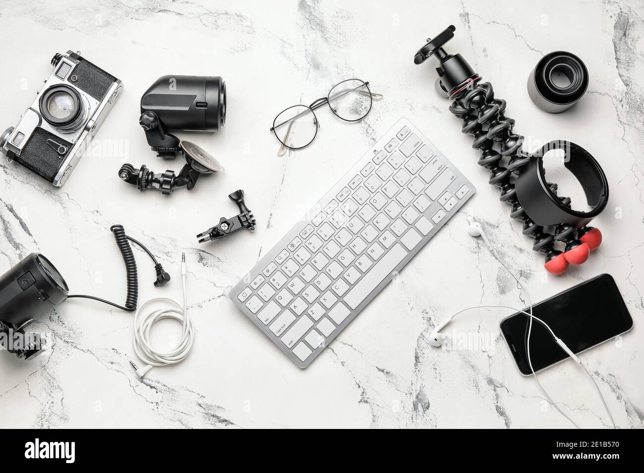 Computer keyboard and modern photographer's equipment on light ...