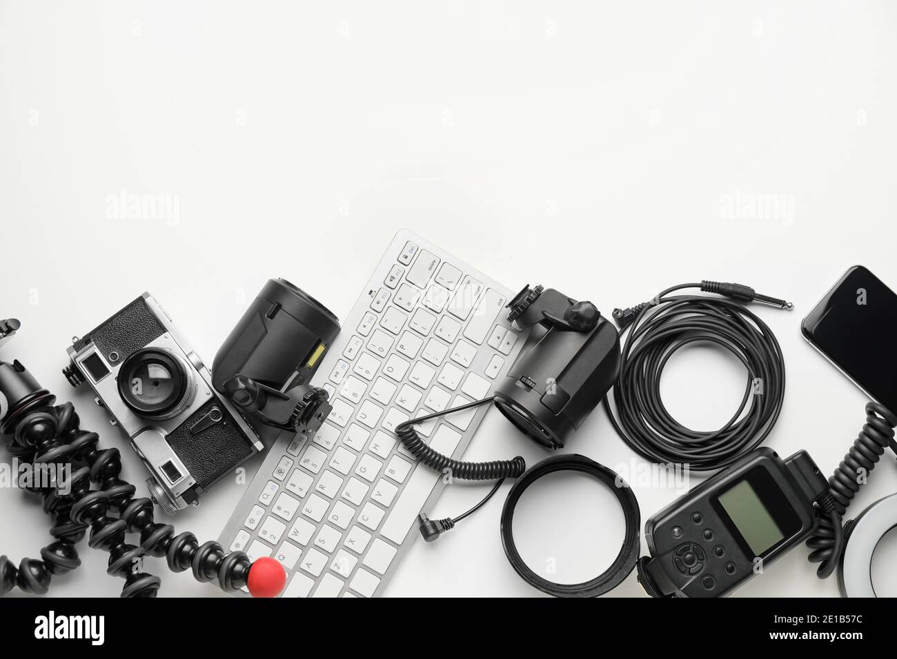 Computer keyboard and modern photographer's equipment on white ...