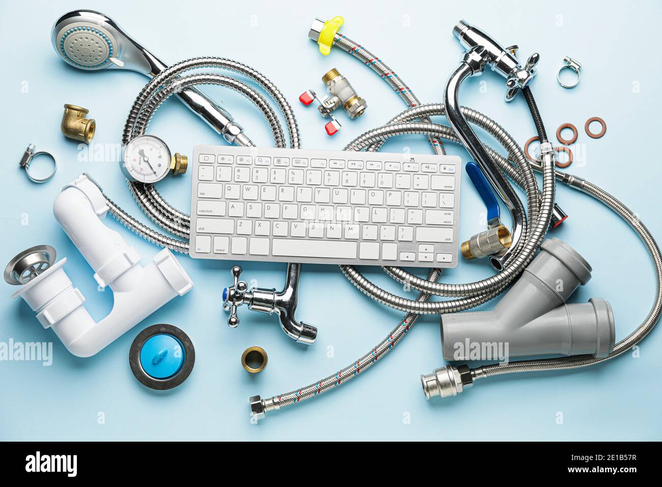 Plumbing items and computer keyboard on color background Stock Photo ...