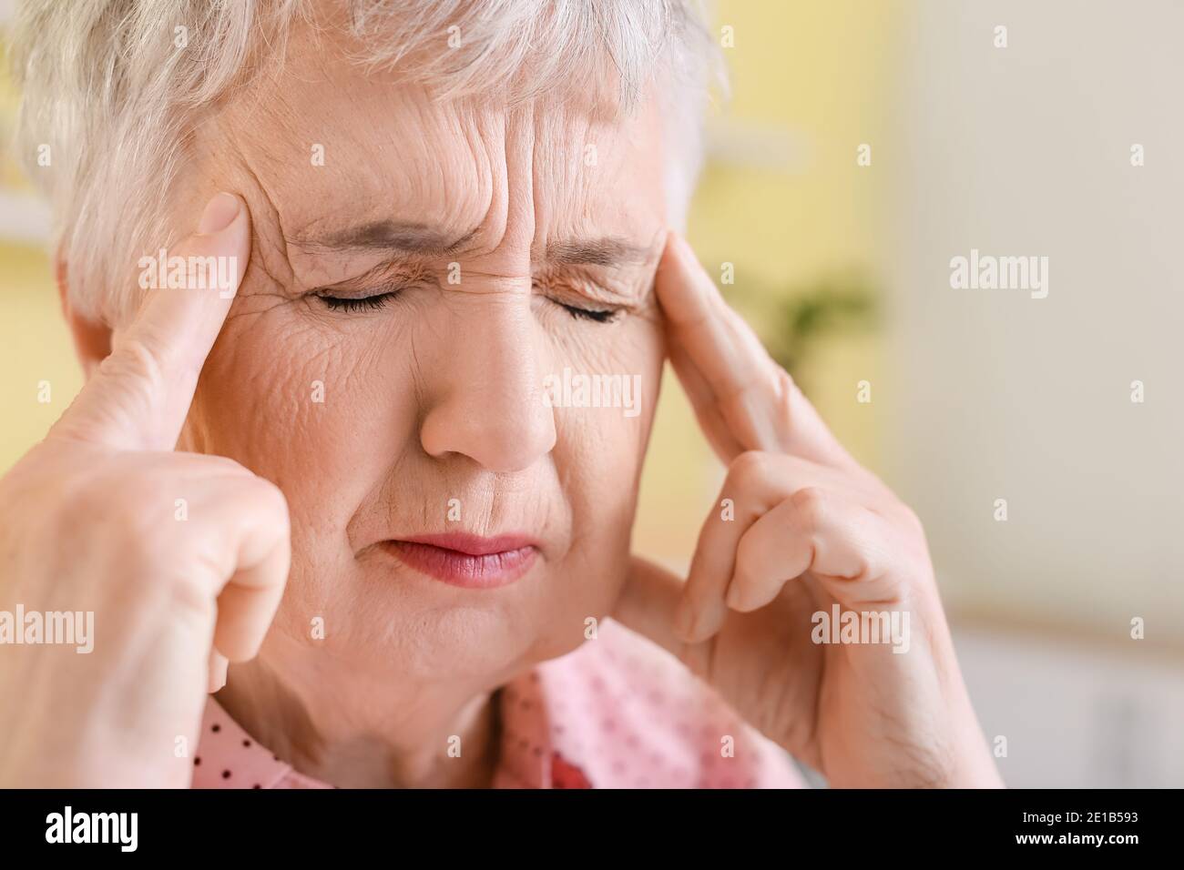 Stressed senior woman suffering from headache Stock Photo - Alamy