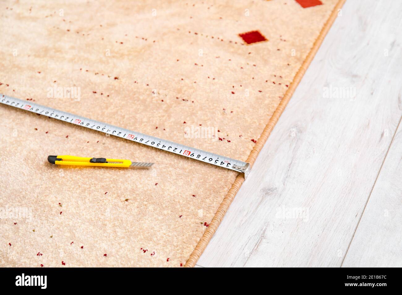 Measuring tape and knife on carpet Stock Photo - Alamy