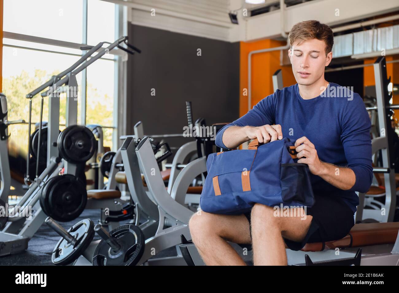 Young man with sport bag in gym Stock Photo - Alamy