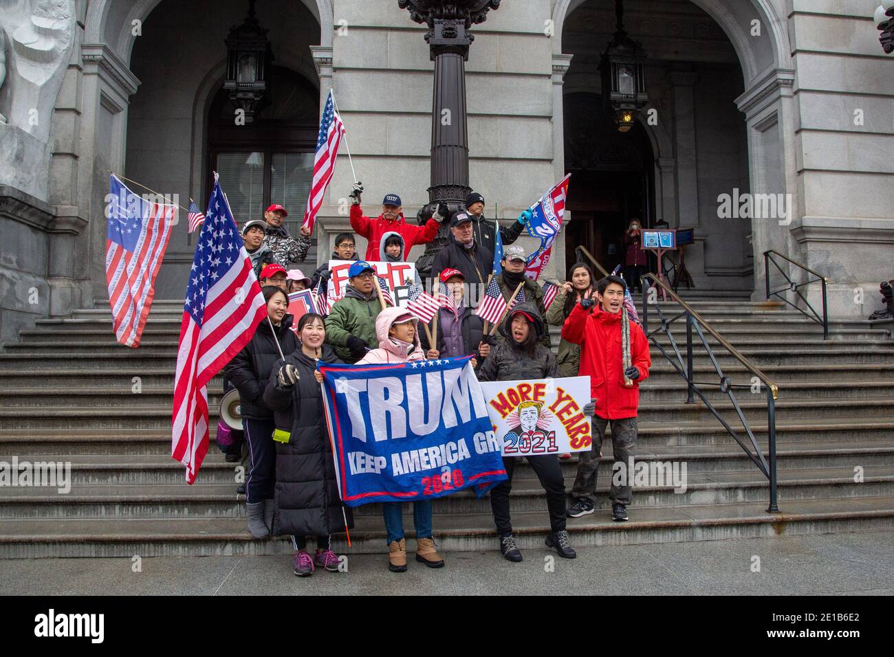 Protesters hold pro-Trump placards and flags on the steps of the ...