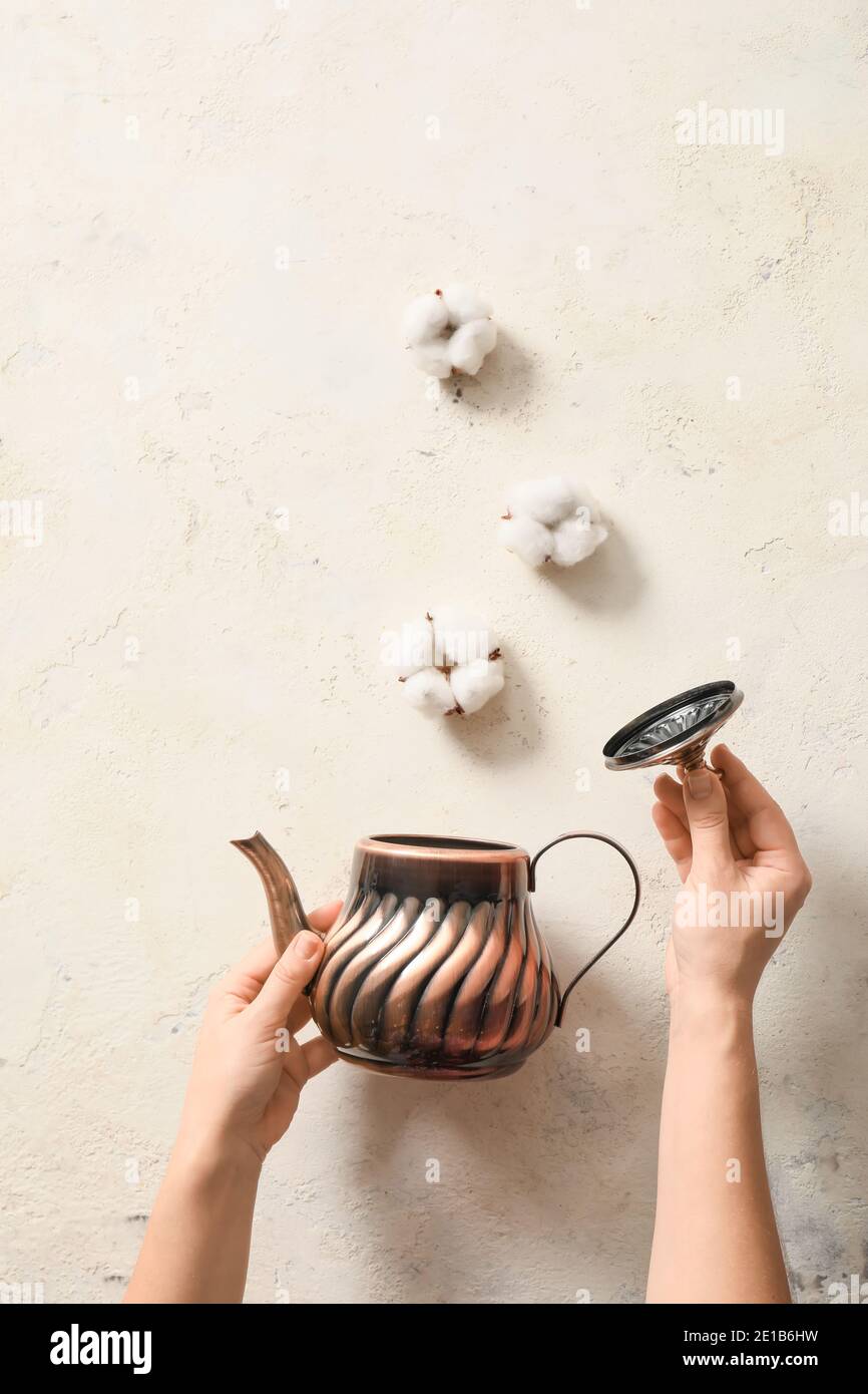 Hands with teapot hi-res stock photography and images - Alamy