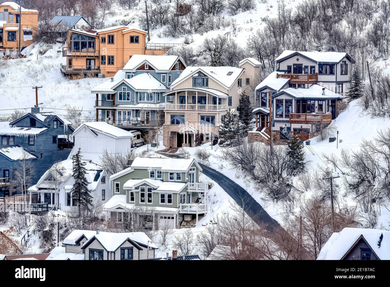 Aerial view of snowy neighborhood in winter on a mountain town with ...