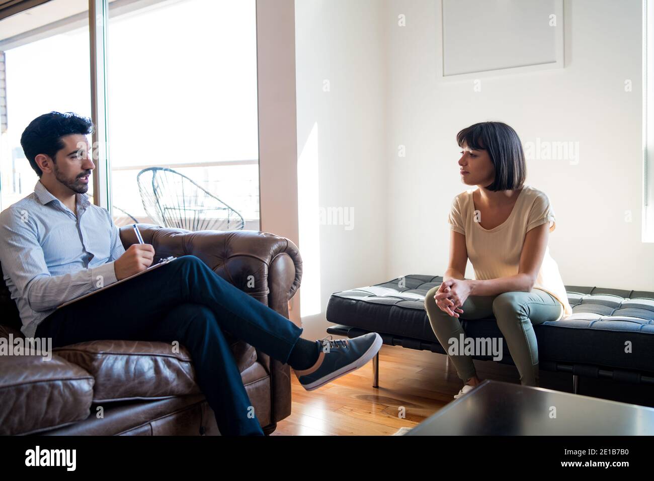 Psychologist talking with patient on therapy session Stock Photo - Alamy