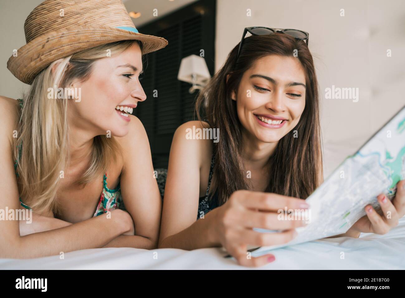 Two travelers friends organizing their trip at hotel room Stock Photo ...