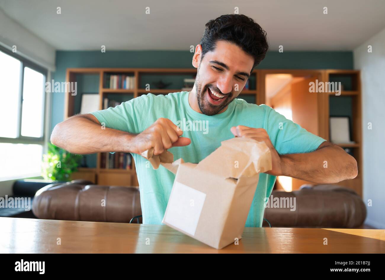 Surprised man opening a gift box Stock Photo - Alamy