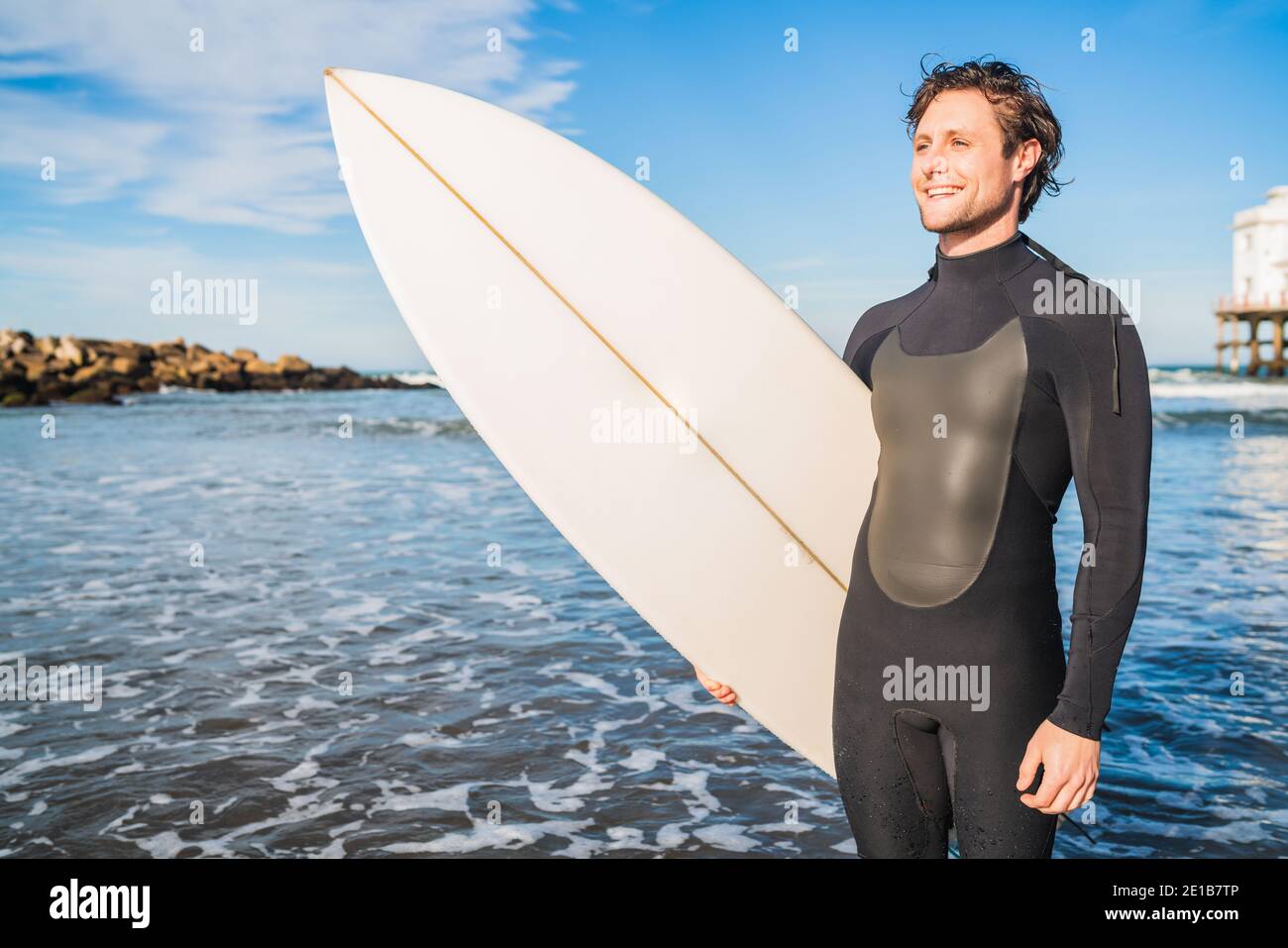 Surfer standing in the sea hi-res stock photography and images - Alamy