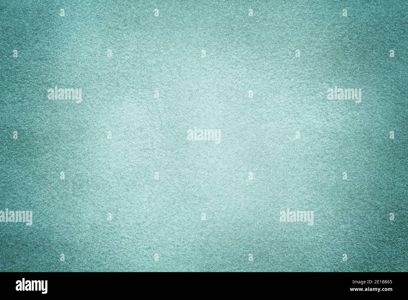 Light blue matte background of suede fabric with dark vignette, closeup ...