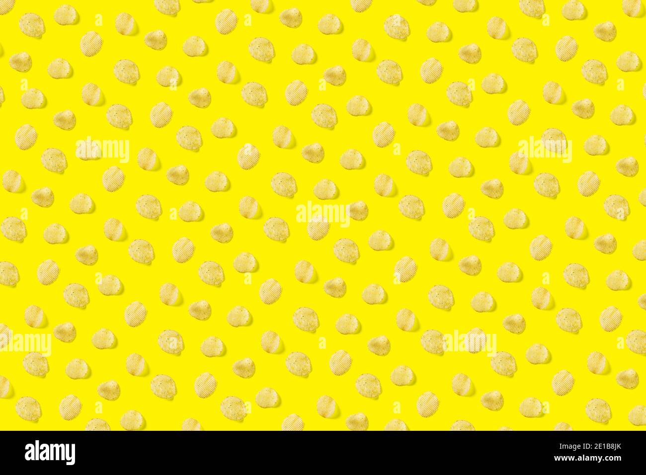 background made from Potato chips on yellow background flat lay. potato ...