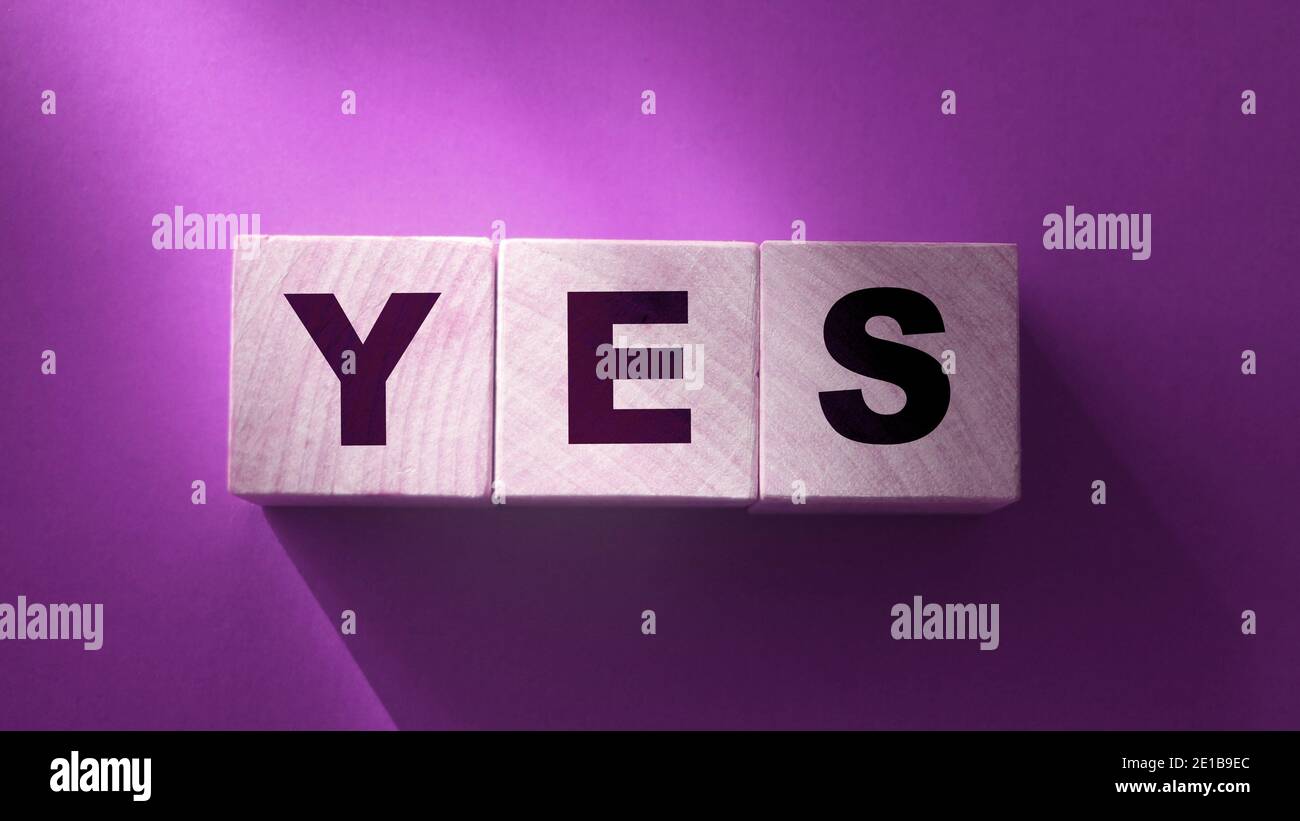 The word Yes written in black letters on wooden blocks. Message spells ...