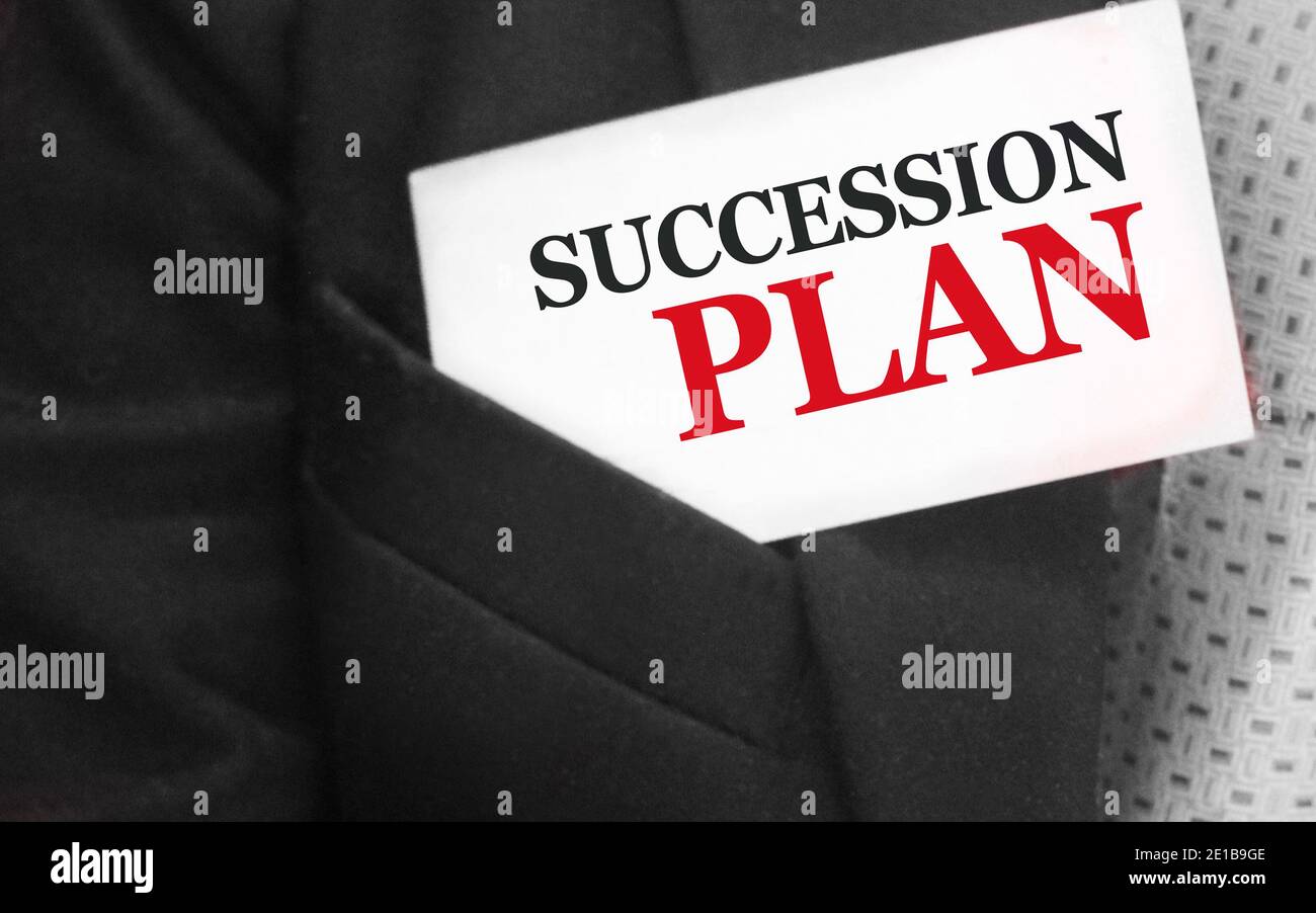 Succession Plan words on a card in upper pocket of businessman wearing ...